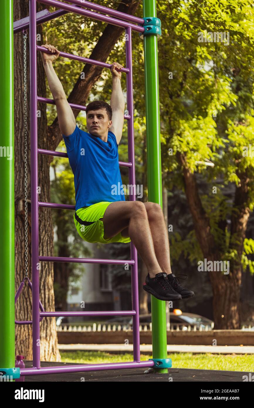 One young handsome caucasian man in sportswear training, exercising on ...