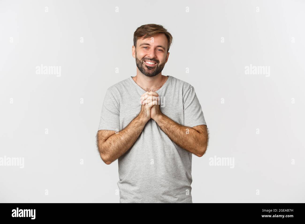 Image of handsome thankful man, holding hands together and expressing ...