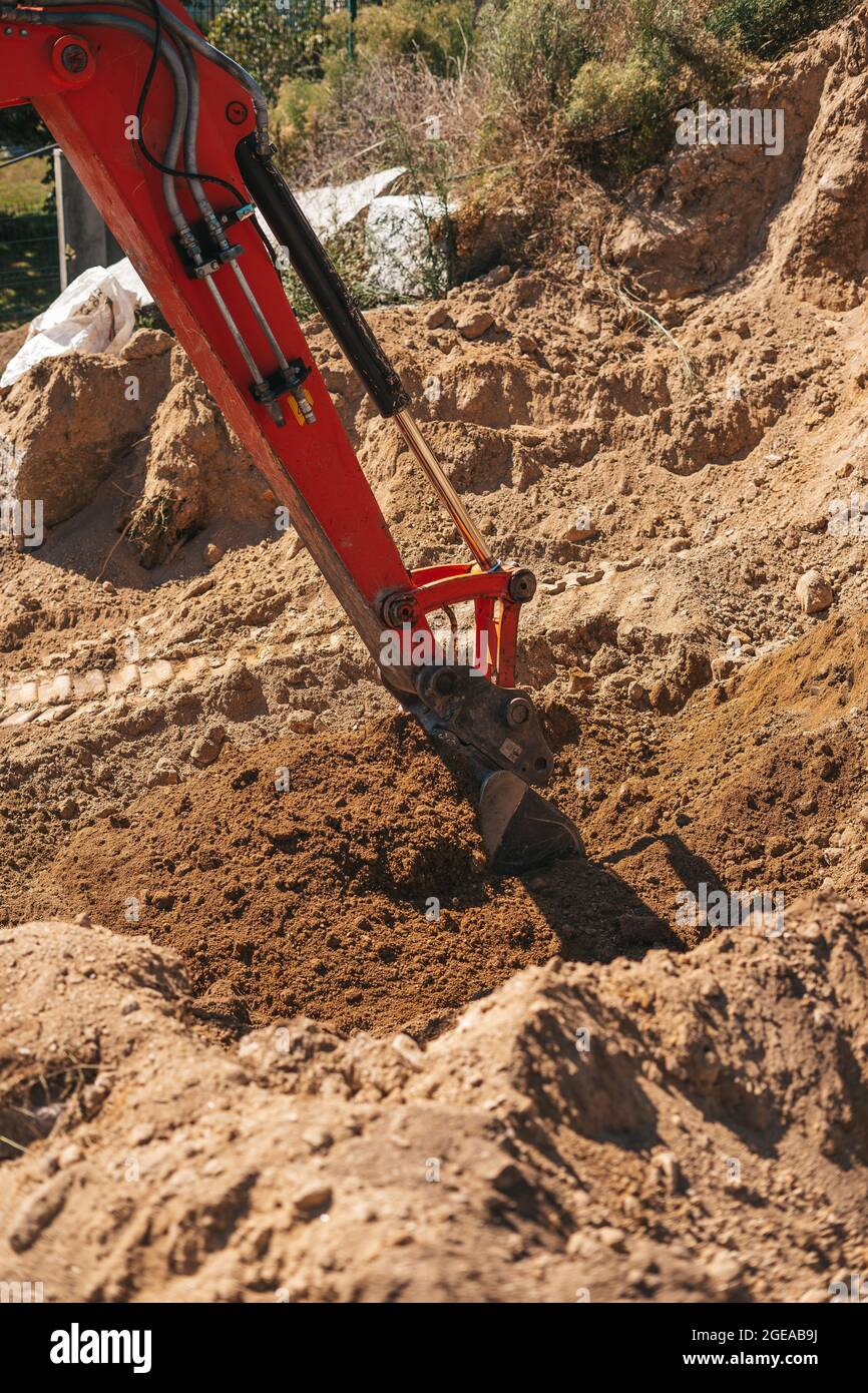 Excavator shovel digging on dirt on a construction site Stock Photo - Alamy