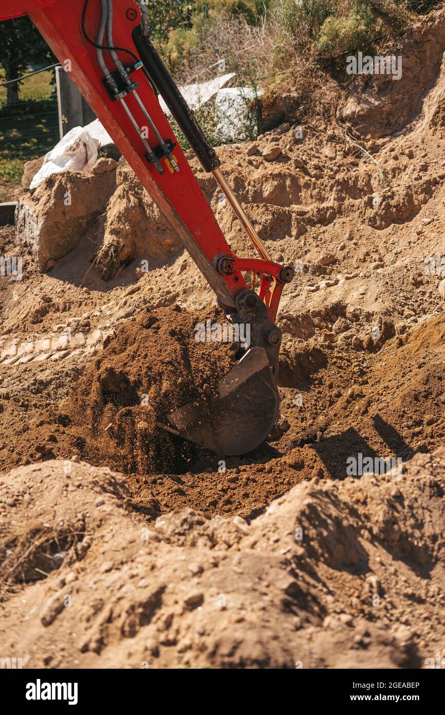 Excavator shovel digging on dirt on a construction site Stock Photo - Alamy