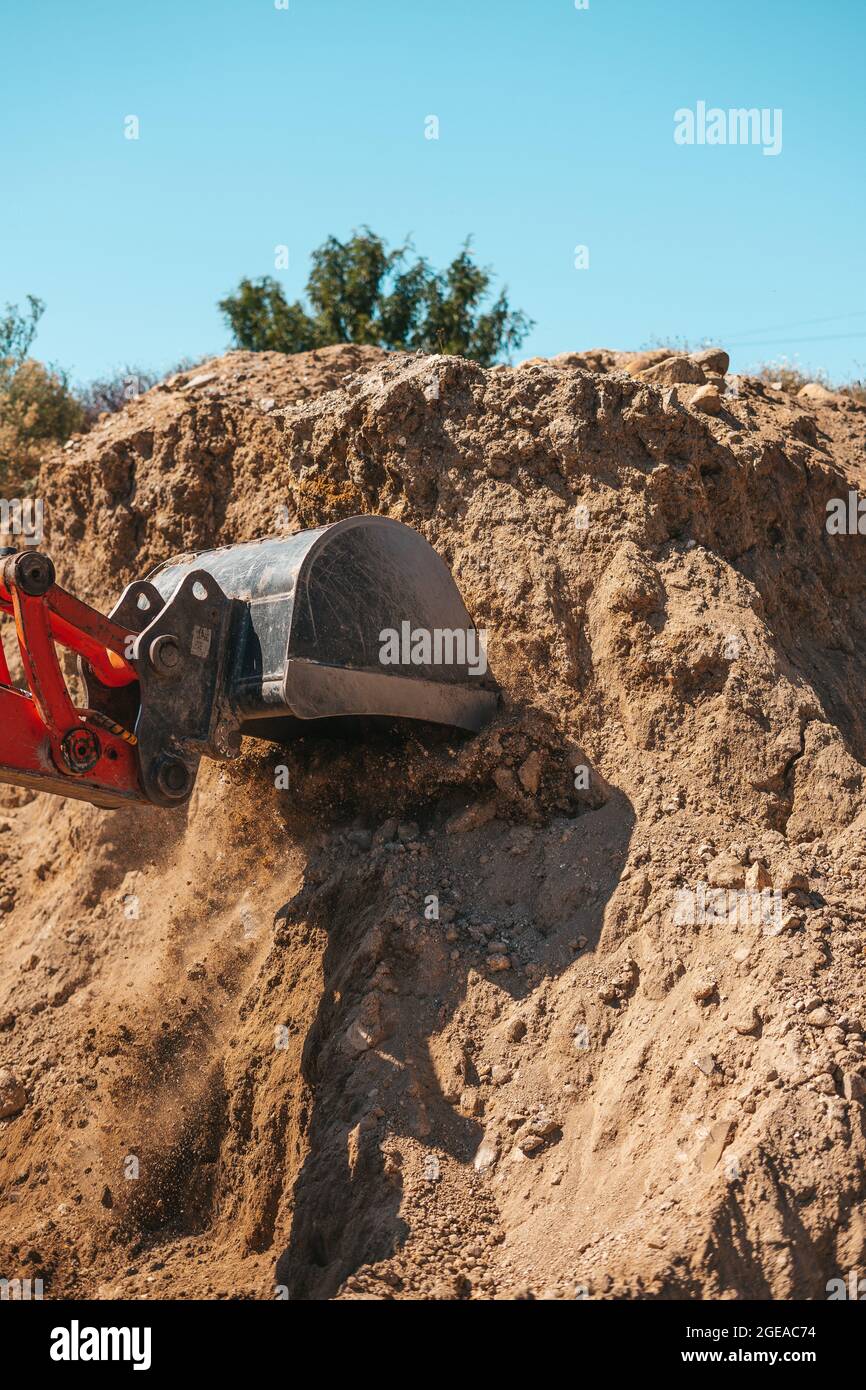 Excavator shovel digging on dirt on a construction site Stock Photo - Alamy