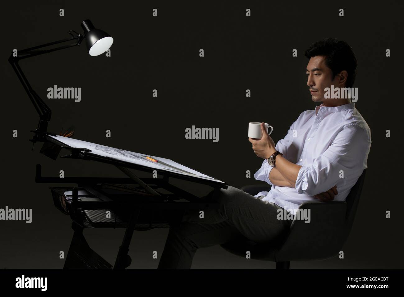 Chinese designer working on construction plan Stock Photo - Alamy