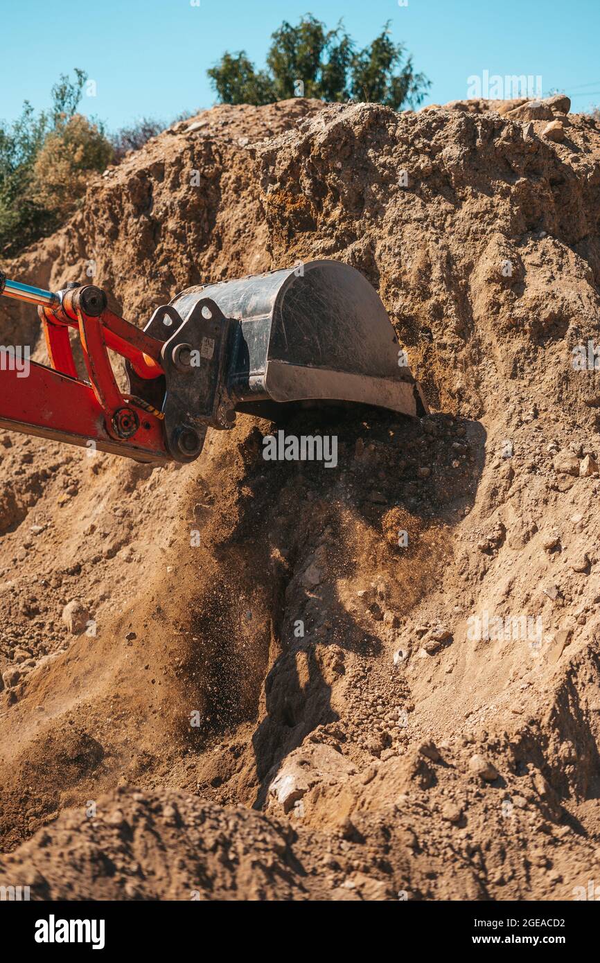 Excavator shovel digging on dirt on a construction site Stock Photo - Alamy