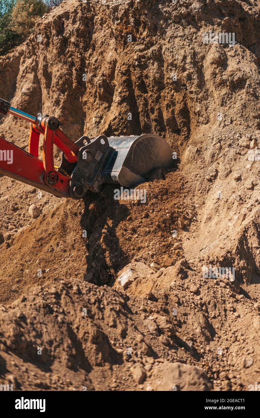 Excavator shovel digging on dirt on a construction site Stock Photo - Alamy