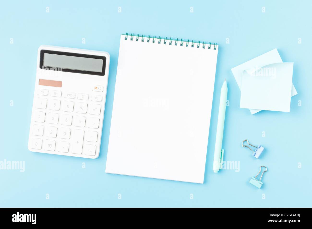 Office desk with calculator, notepad and glasses Stock Photo - Alamy
