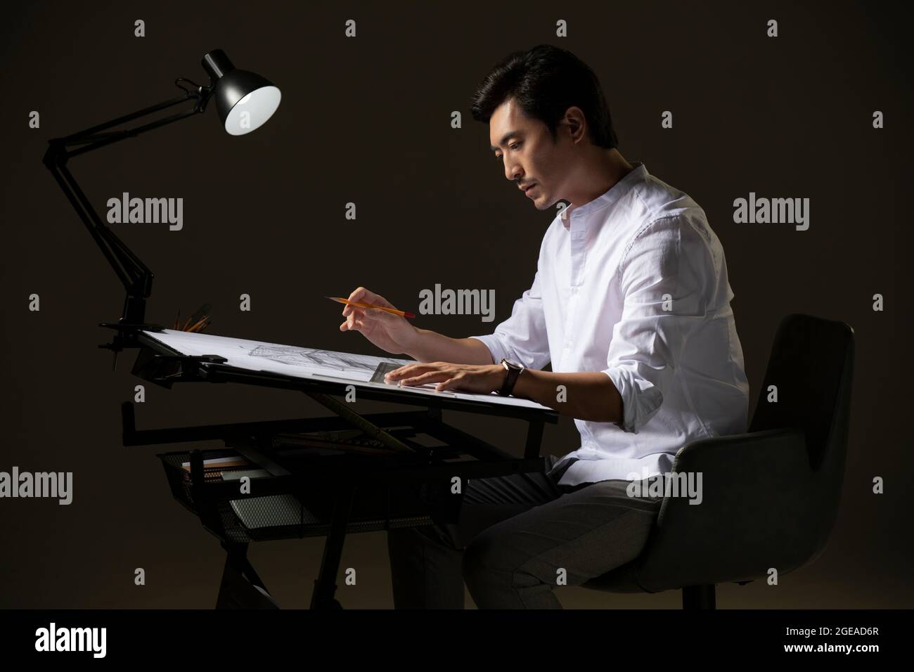 Chinese designer working on construction plan Stock Photo - Alamy