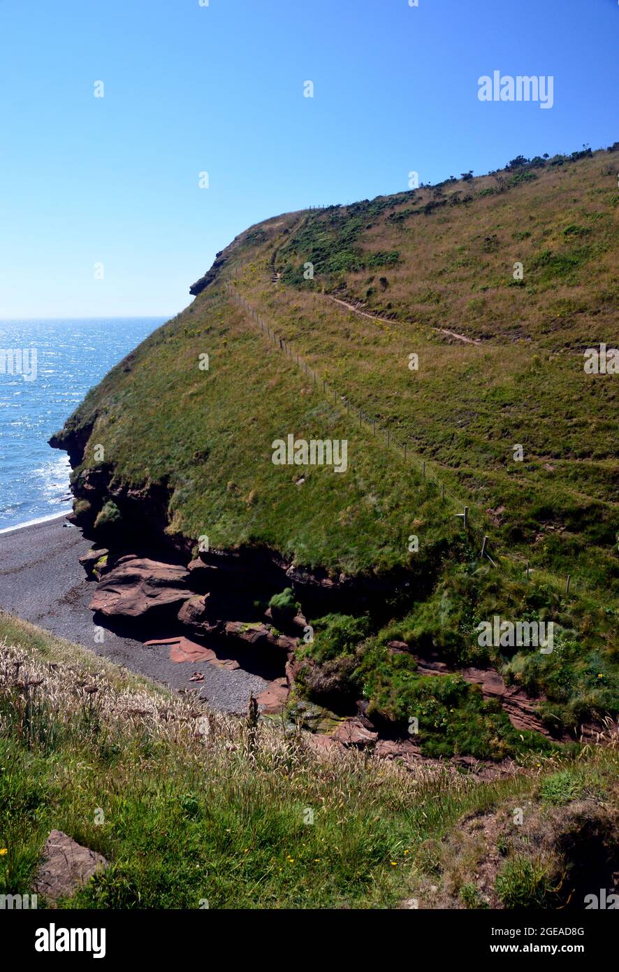 The Red Sandstone Cliffs at Fleswick Bay on the Clifftop Coastal Path ...