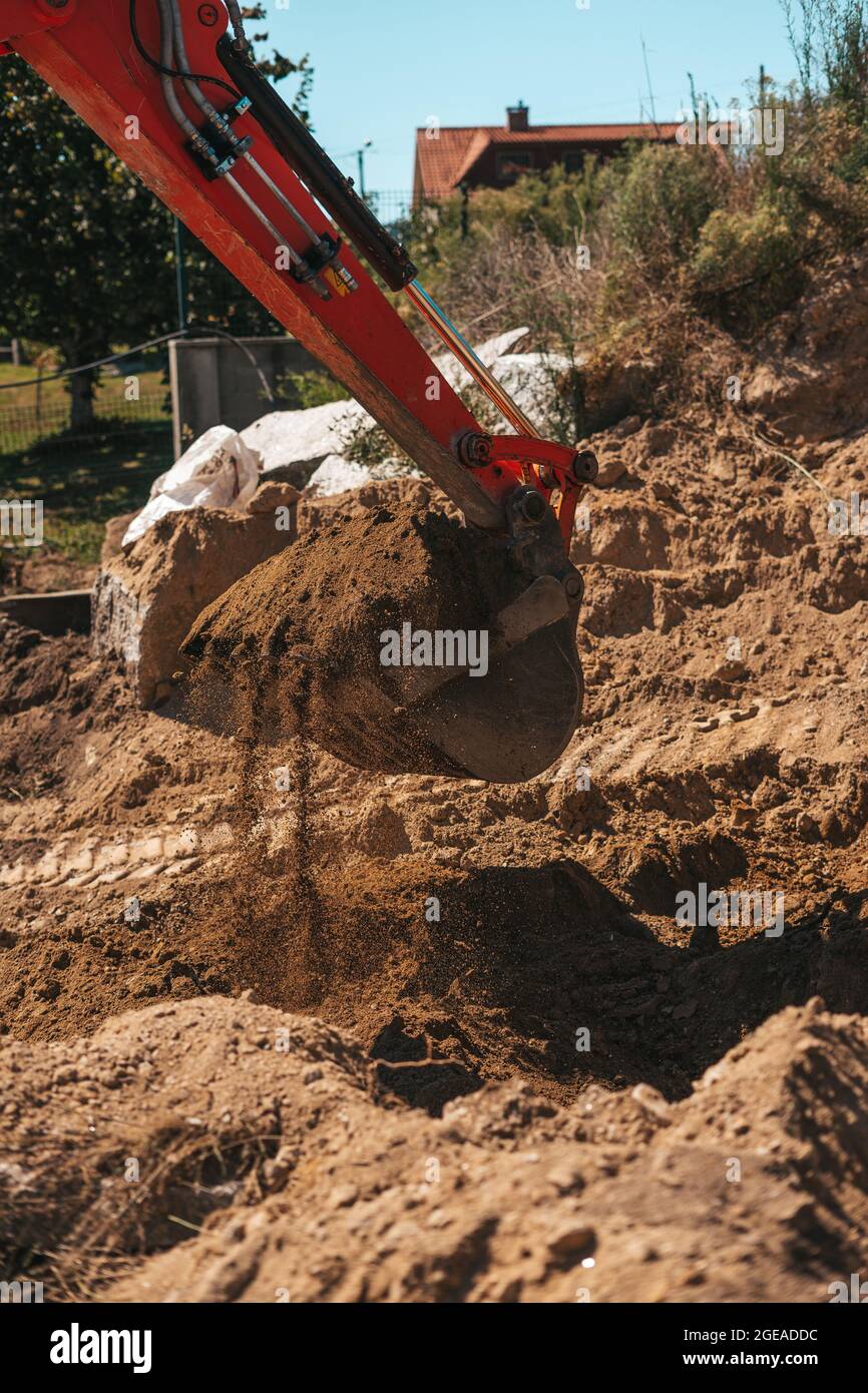 Excavator shovel digging on dirt on a construction site Stock Photo - Alamy