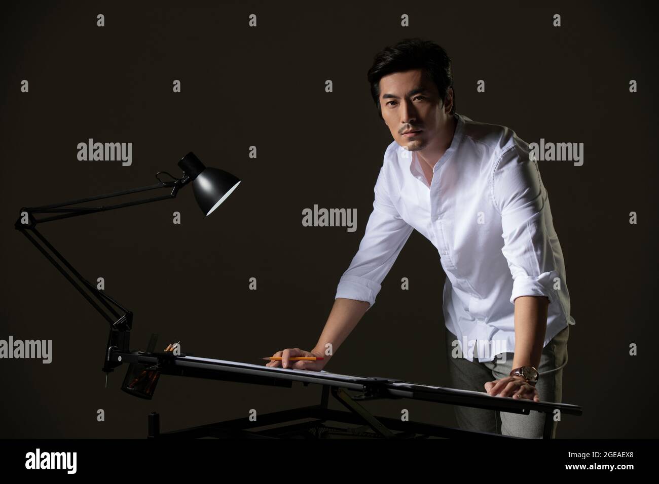 Chinese designer working on construction plan Stock Photo - Alamy