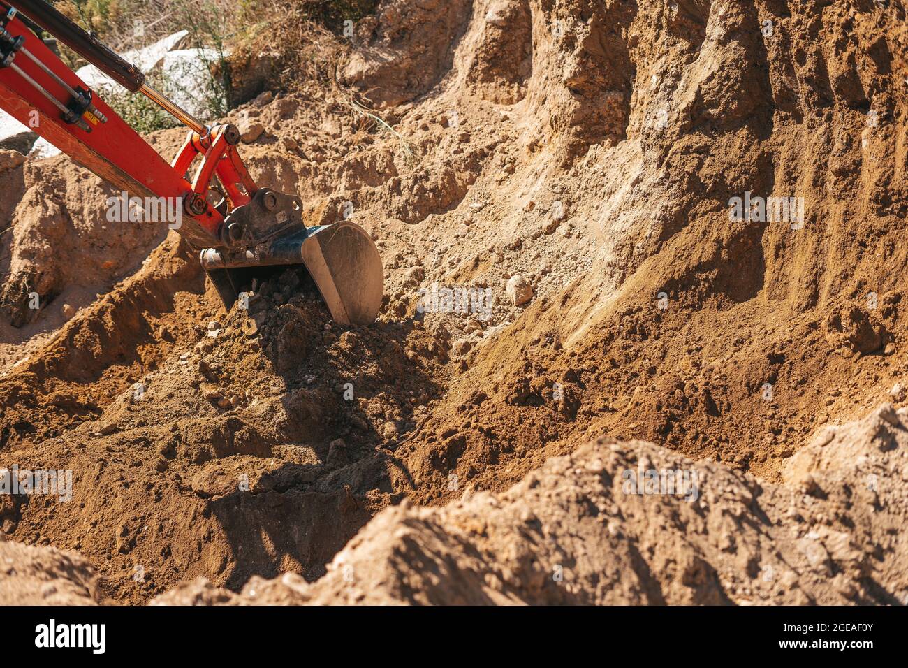 Excavator shovel digging on dirt on a construction site Stock Photo - Alamy