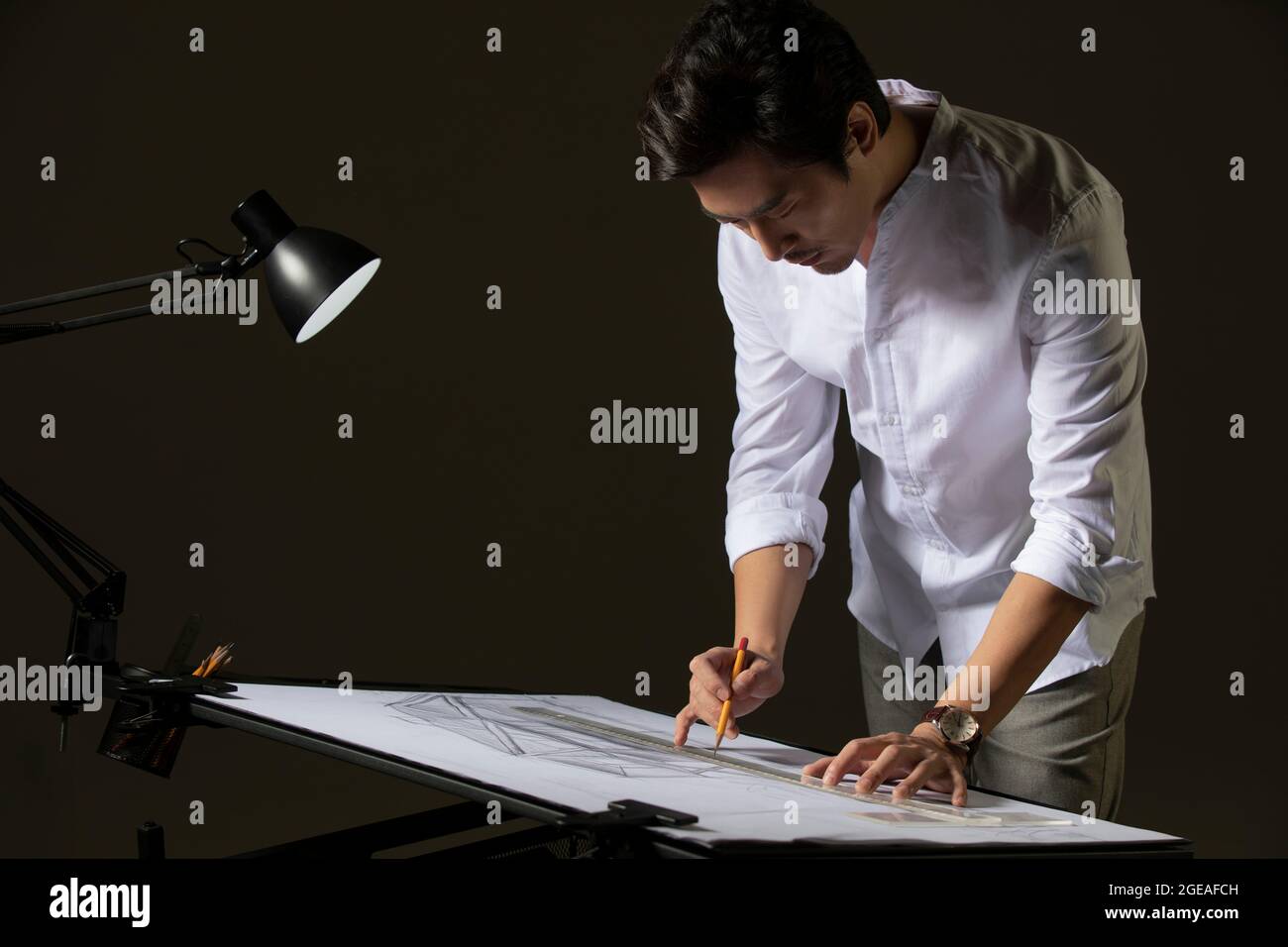 Chinese designer working on construction plan Stock Photo - Alamy