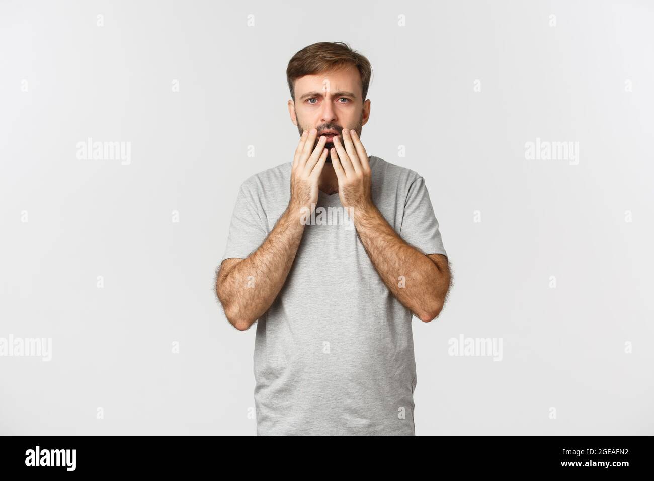 Portrait of shocked and worried guy staring at something disturbing ...