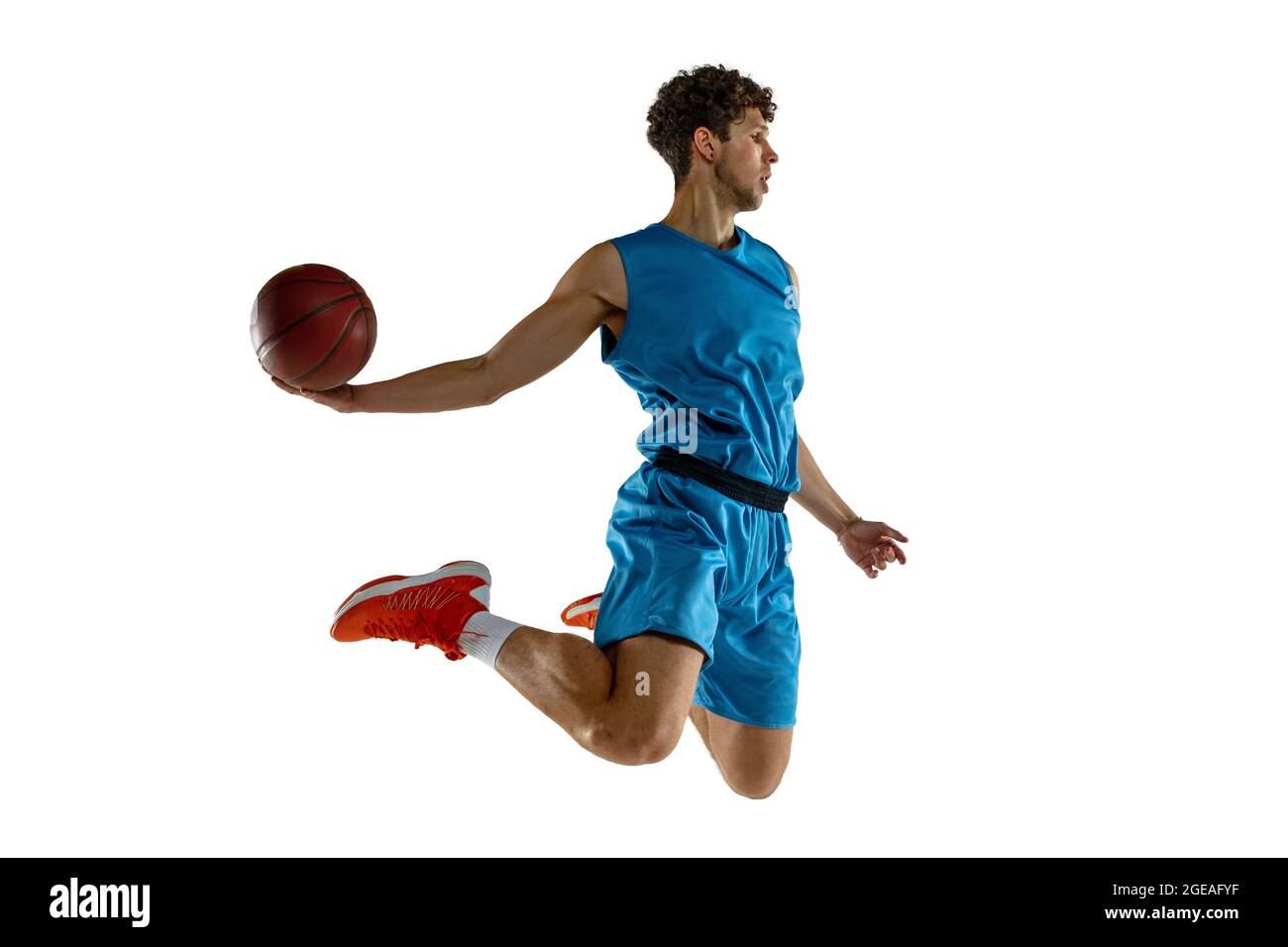 Side view. Young caucasian professional basketball player exercising ...