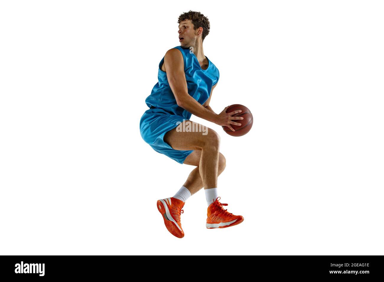 Young caucasian professional basketball player exercising with ball ...
