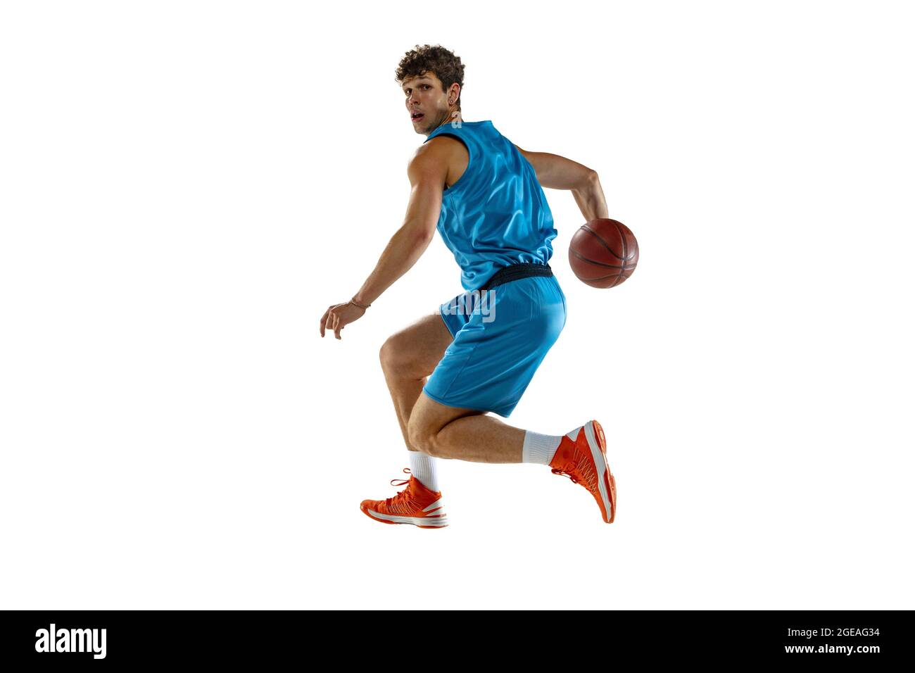 Young caucasian professional basketball player exercising with ball ...