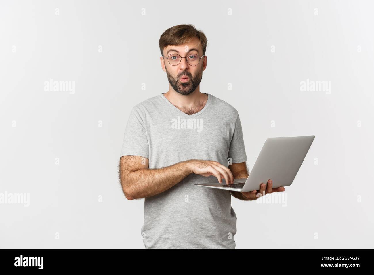 Image of surprised male model in glasses and gray t-shirt, looking ...