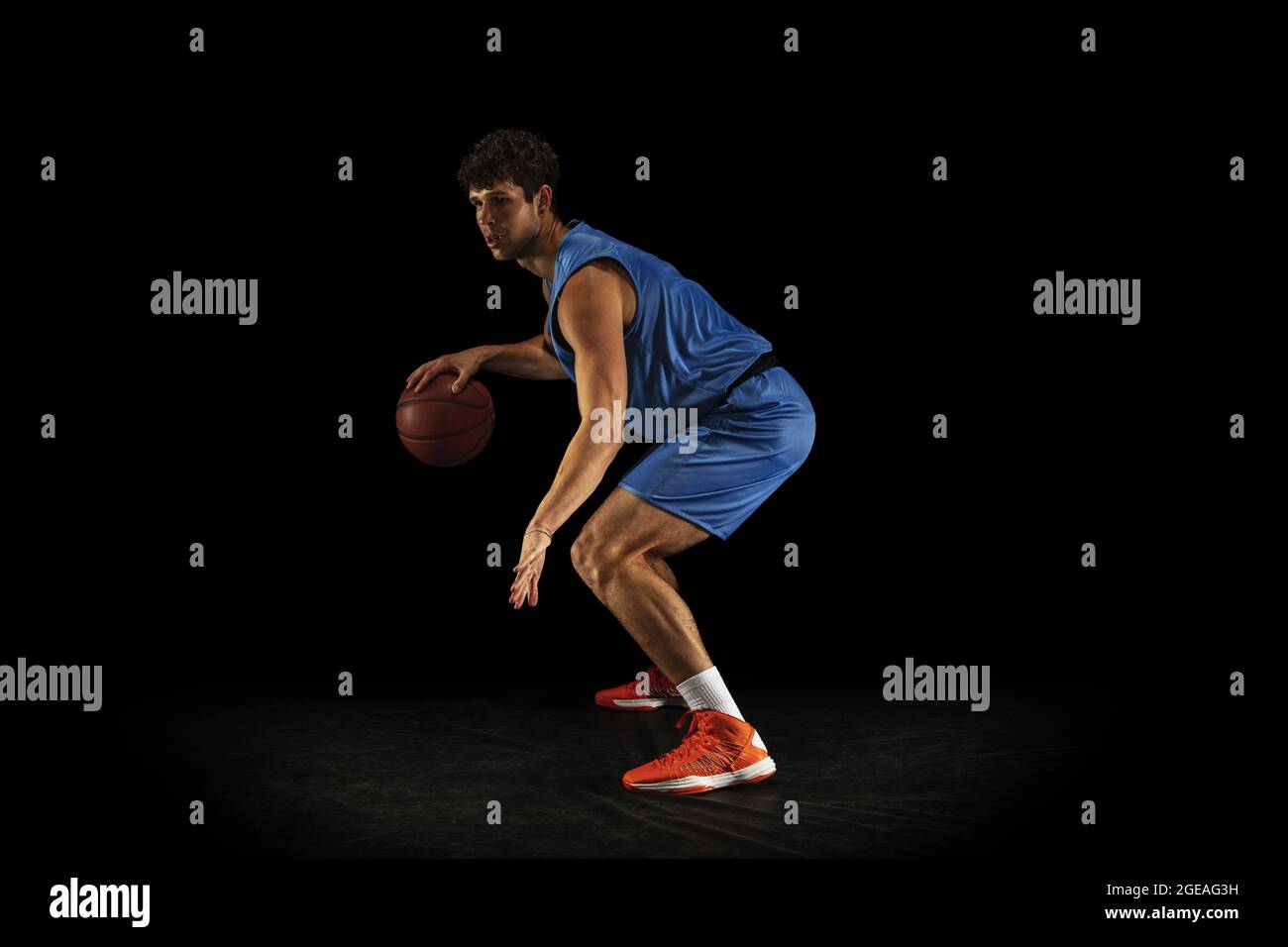 Side view. One young caucasian professional basketball player ...