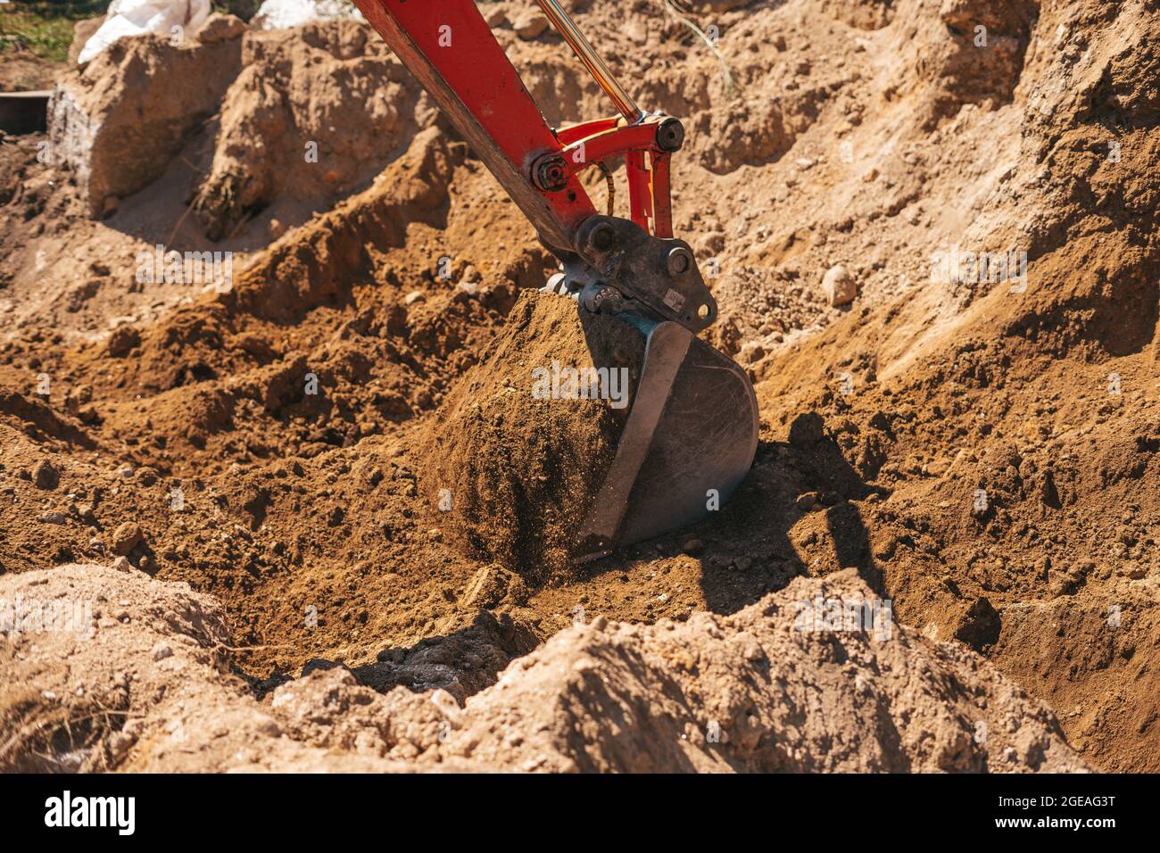 Excavator shovel digging on dirt on a construction site Stock Photo - Alamy
