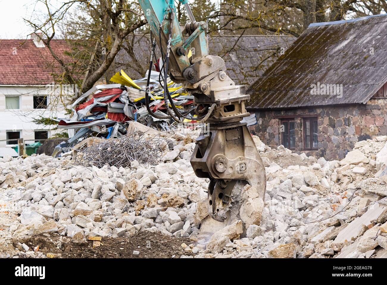Old stone building demolition with excavator Stock Photo - Alamy