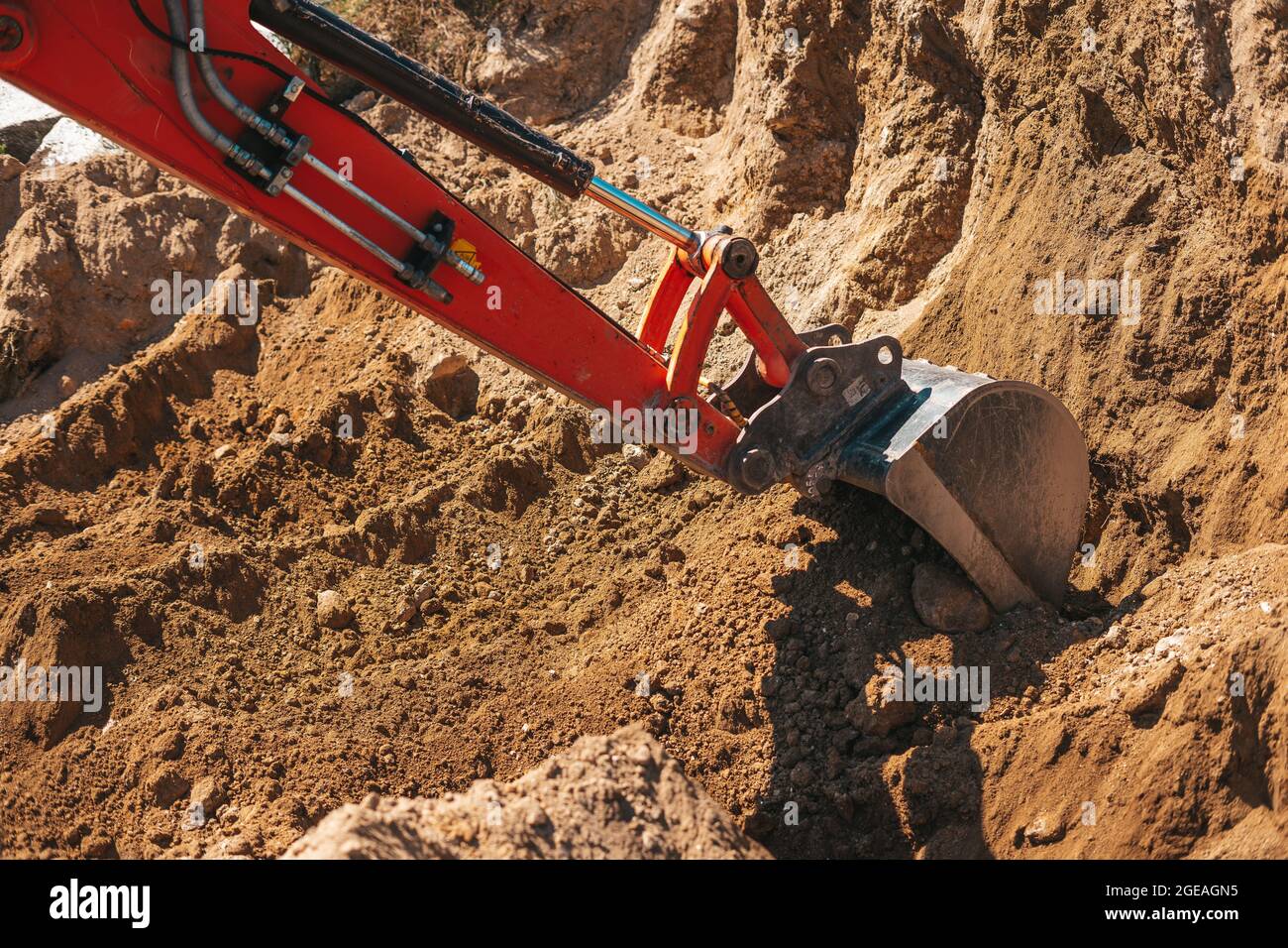Excavator shovel digging on dirt on a construction site Stock Photo - Alamy