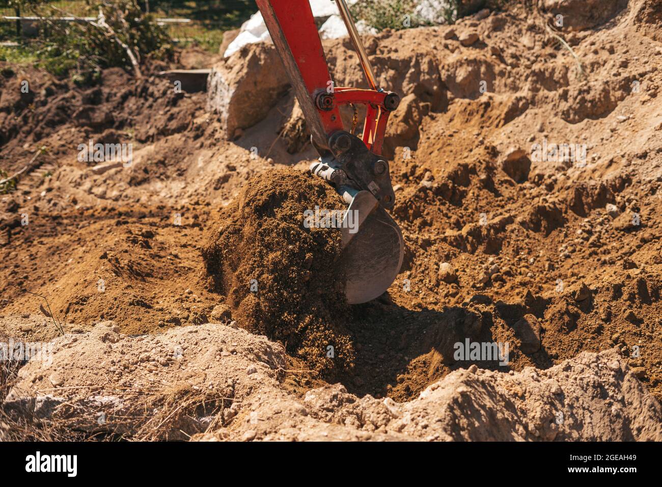 Excavator shovel digging on dirt on a construction site Stock Photo - Alamy