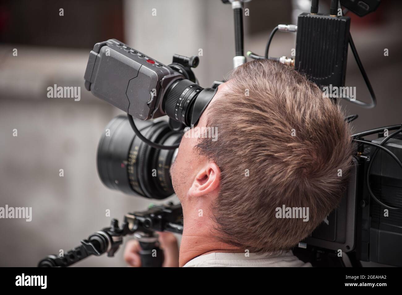 Behind the scene. Cameraman shooting the film scene with his camera on ...
