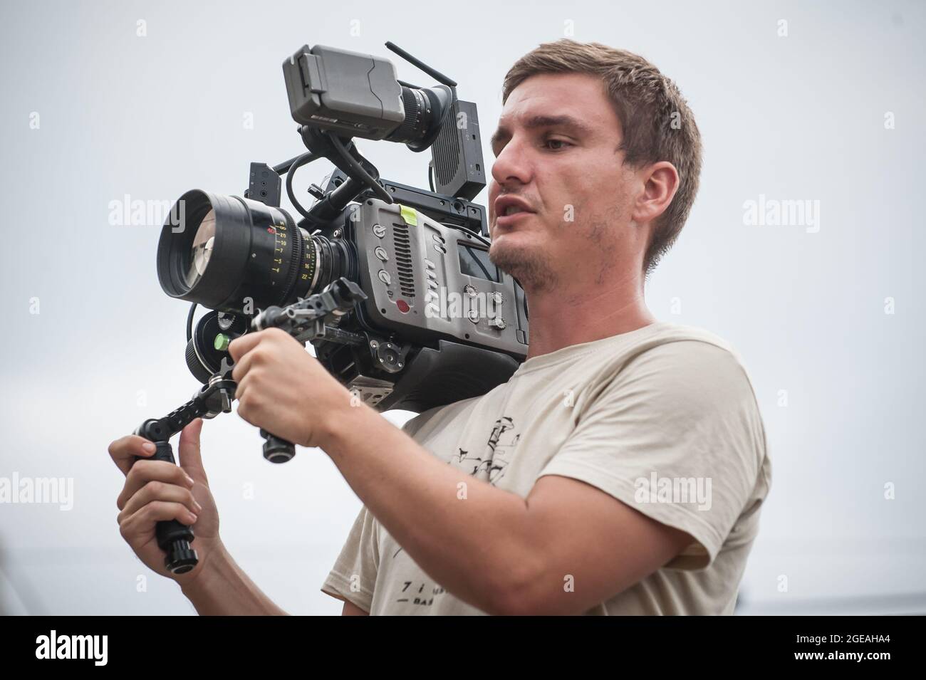 Behind the scene. Cameraman shooting the film scene with his camera on ...