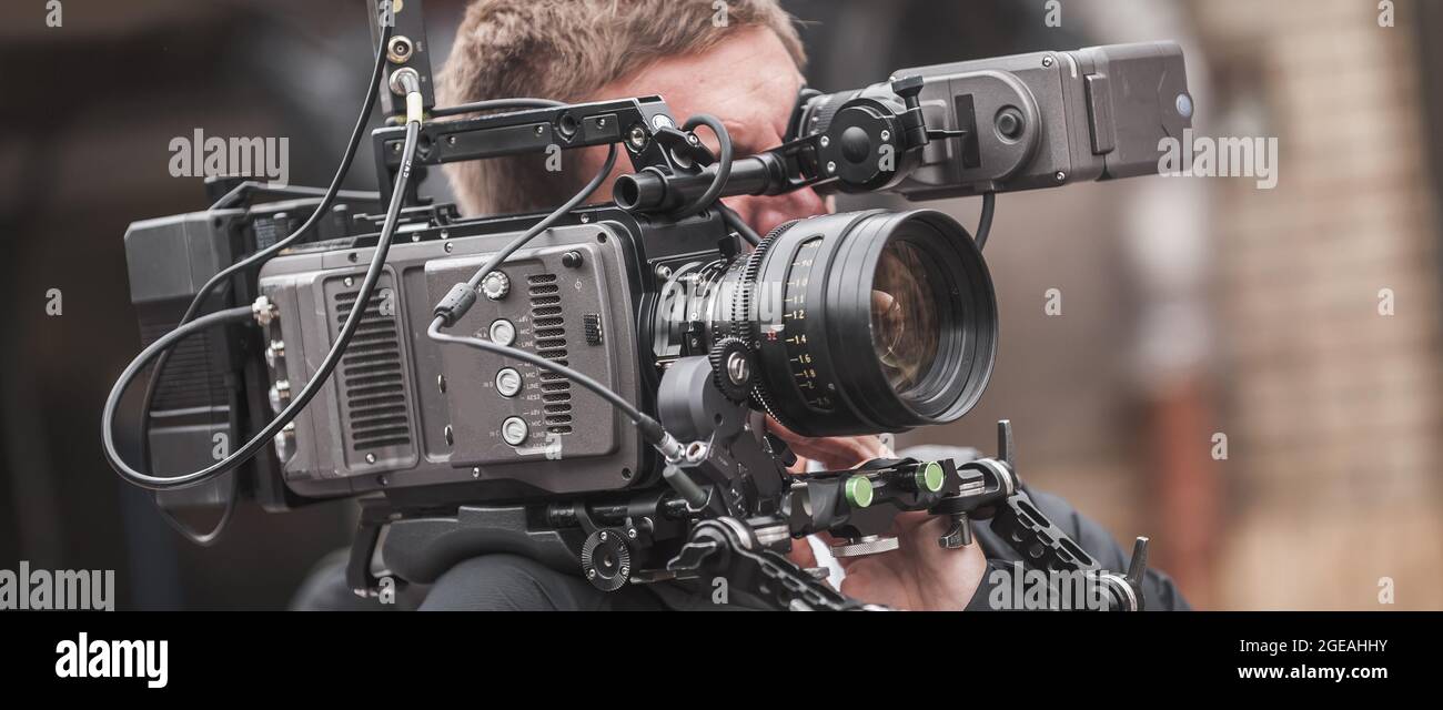 Behind the scene. Cameraman shooting the film scene with his camera on ...