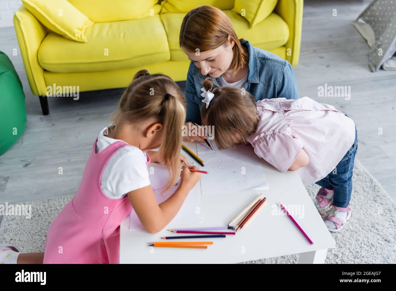 high angle view of happy kindergarten teacher drawing with kids Stock ...