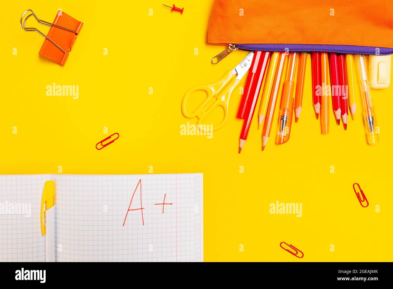 Education. Pencil box with pens and notebook with an excellent grade on ...