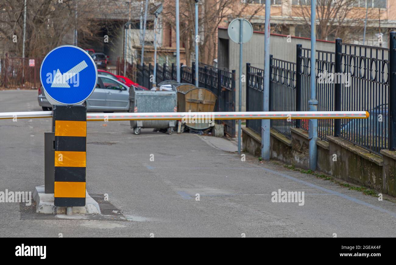 Parking Ramp Barrier Boom and Direction Arrow Sign Stock Photo - Alamy