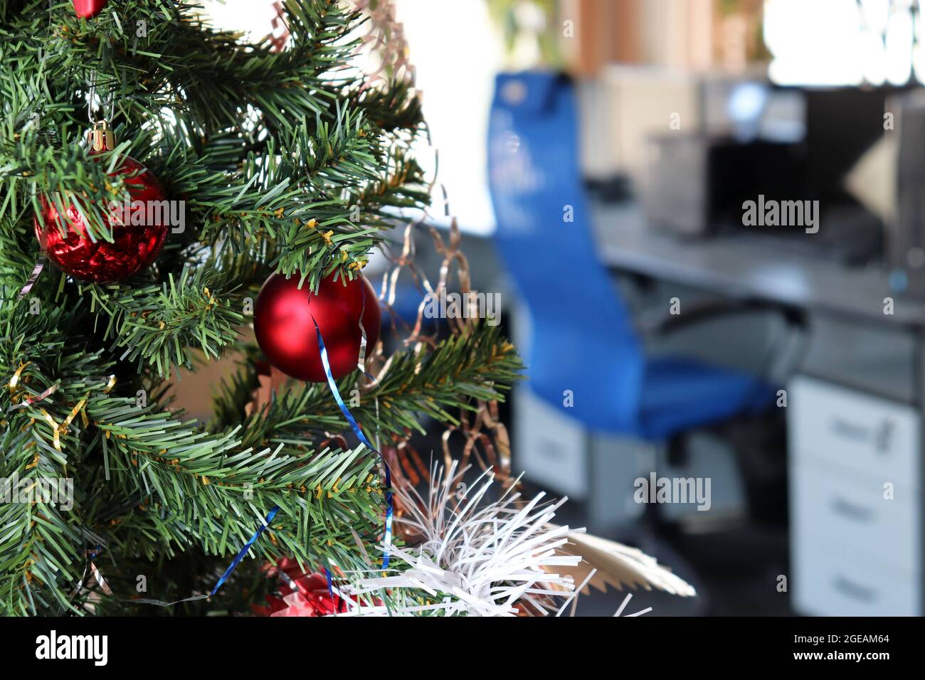 Christmas tree with decorations in office. New Year toys, corporate ...