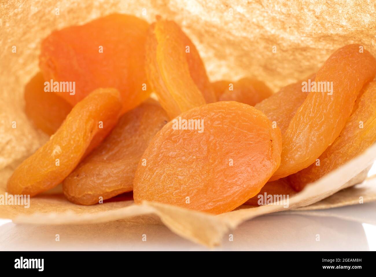 Bright yellow organic dried apricots in brown paper, close-up Stock ...