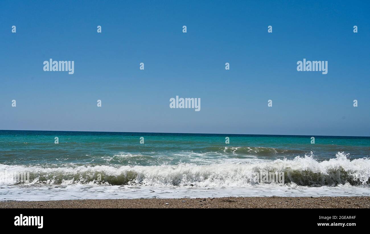 Wavy sea on the edge of the beach Stock Photo - Alamy
