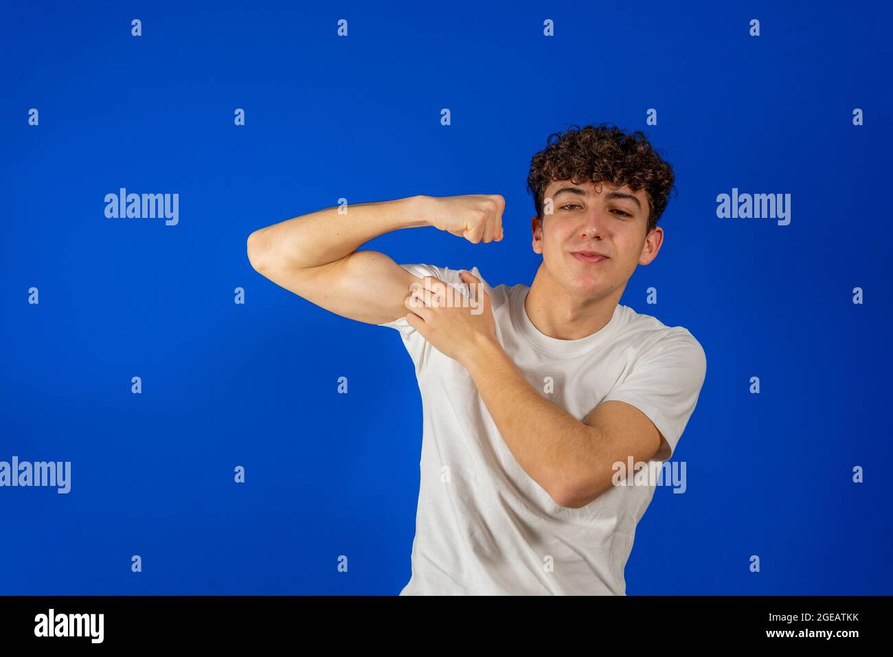 Proud man pointing at his biceps and looking at camera. Portrait of ... Proud man pointing at his biceps and looking at camera. Portrait of ...