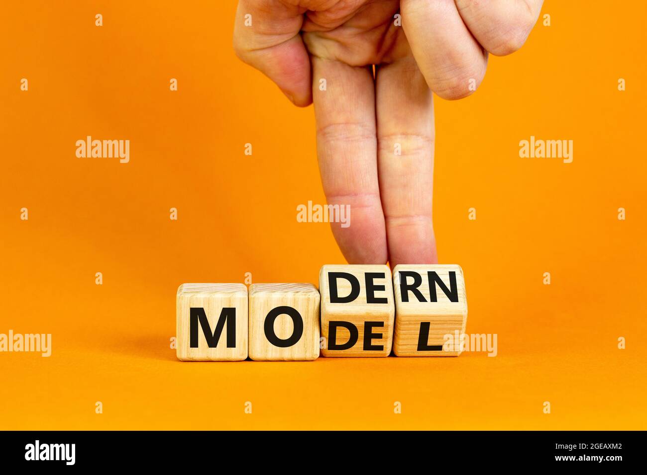 Modern model symbol. Businessman turns wooden cubes and changes the ...