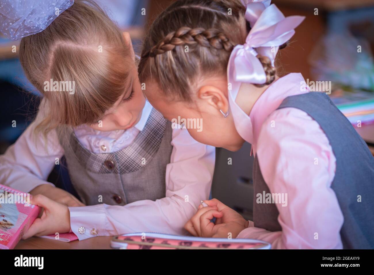 First graders sit at their desks and talk about a non-writing pen ...