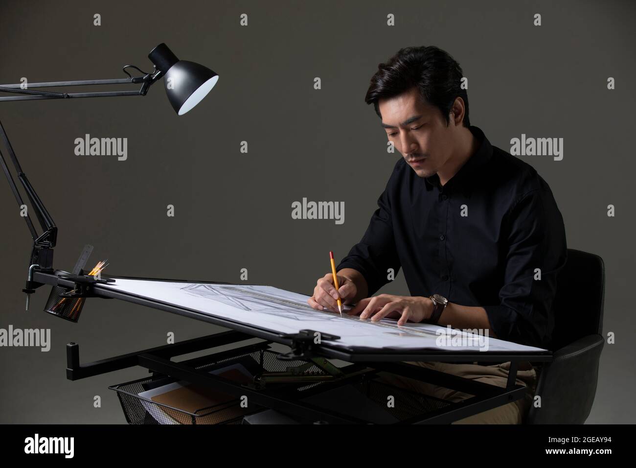 Chinese designer working on construction plan Stock Photo - Alamy