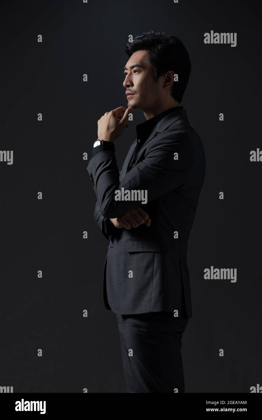Successful Chinese businessman thinking Stock Photo - Alamy