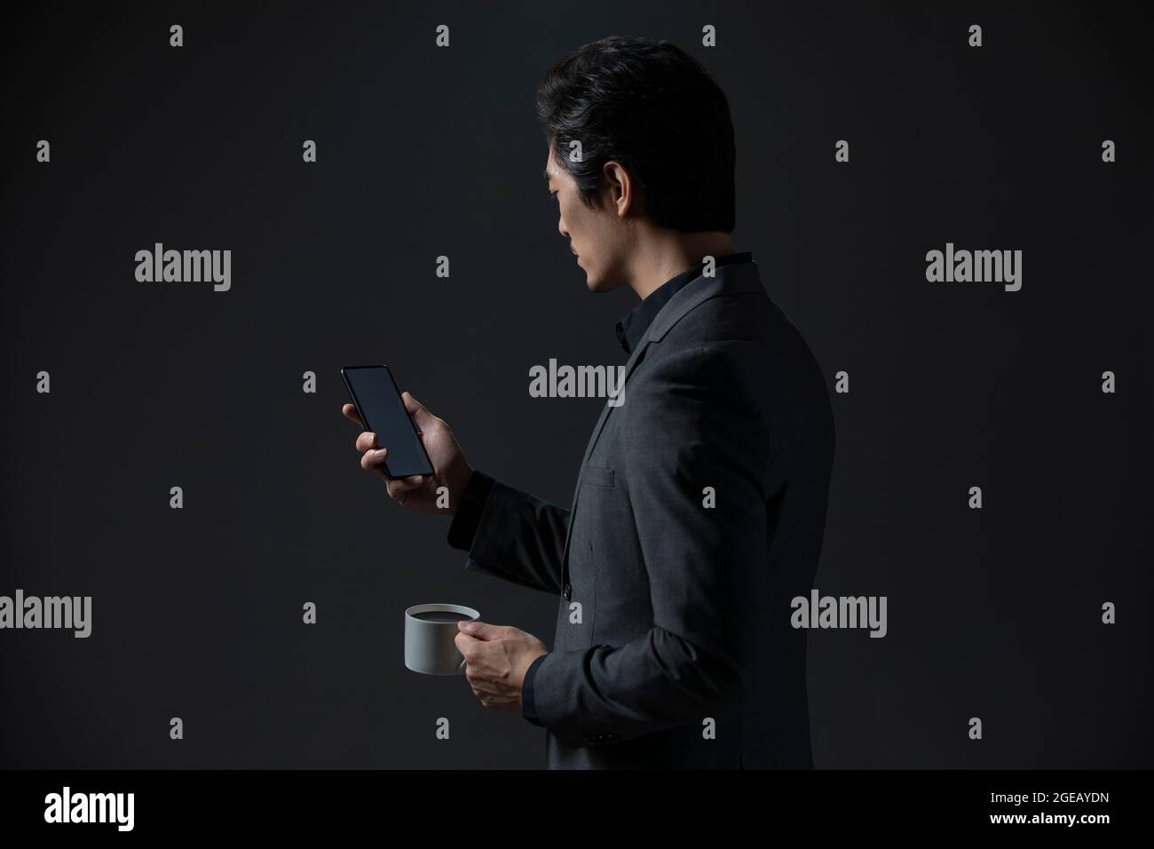 Successful Chinese businessman using smartphone Stock Photo - Alamy