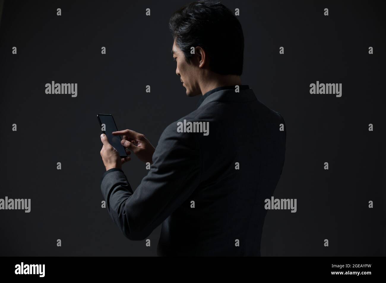 Chinese man touching smartphone hi-res stock photography and images - Alamy
