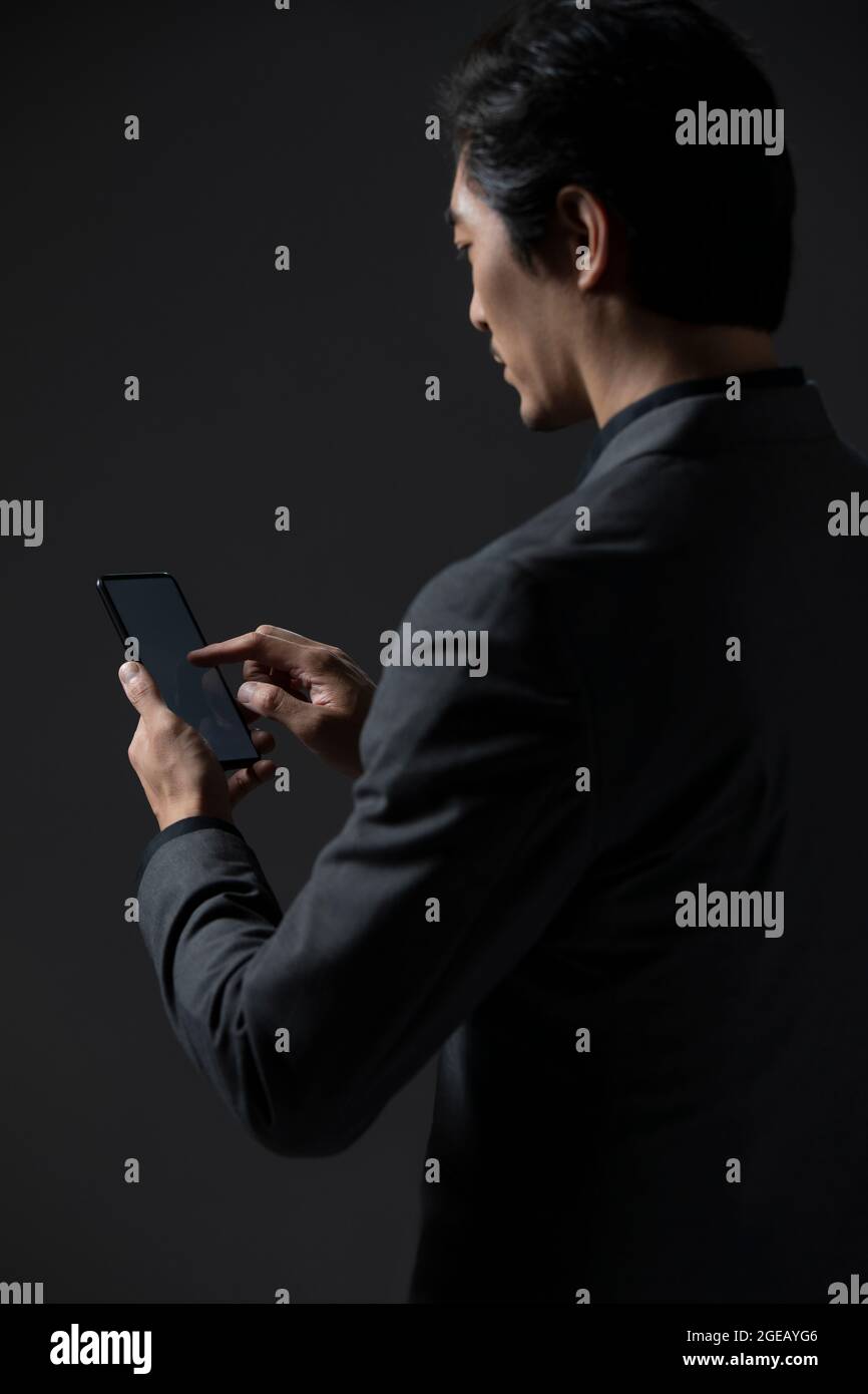 Chinese man touching smartphone hi-res stock photography and images - Alamy