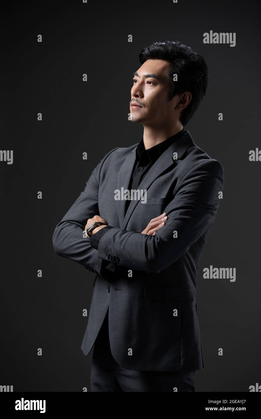 Successful Chinese businessman thinking Stock Photo - Alamy