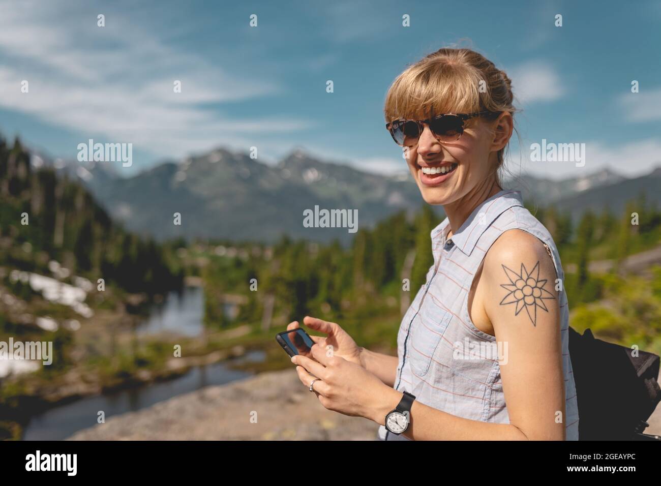Young woman taking pictures at Heather Meadows in the Mt. Baker ...