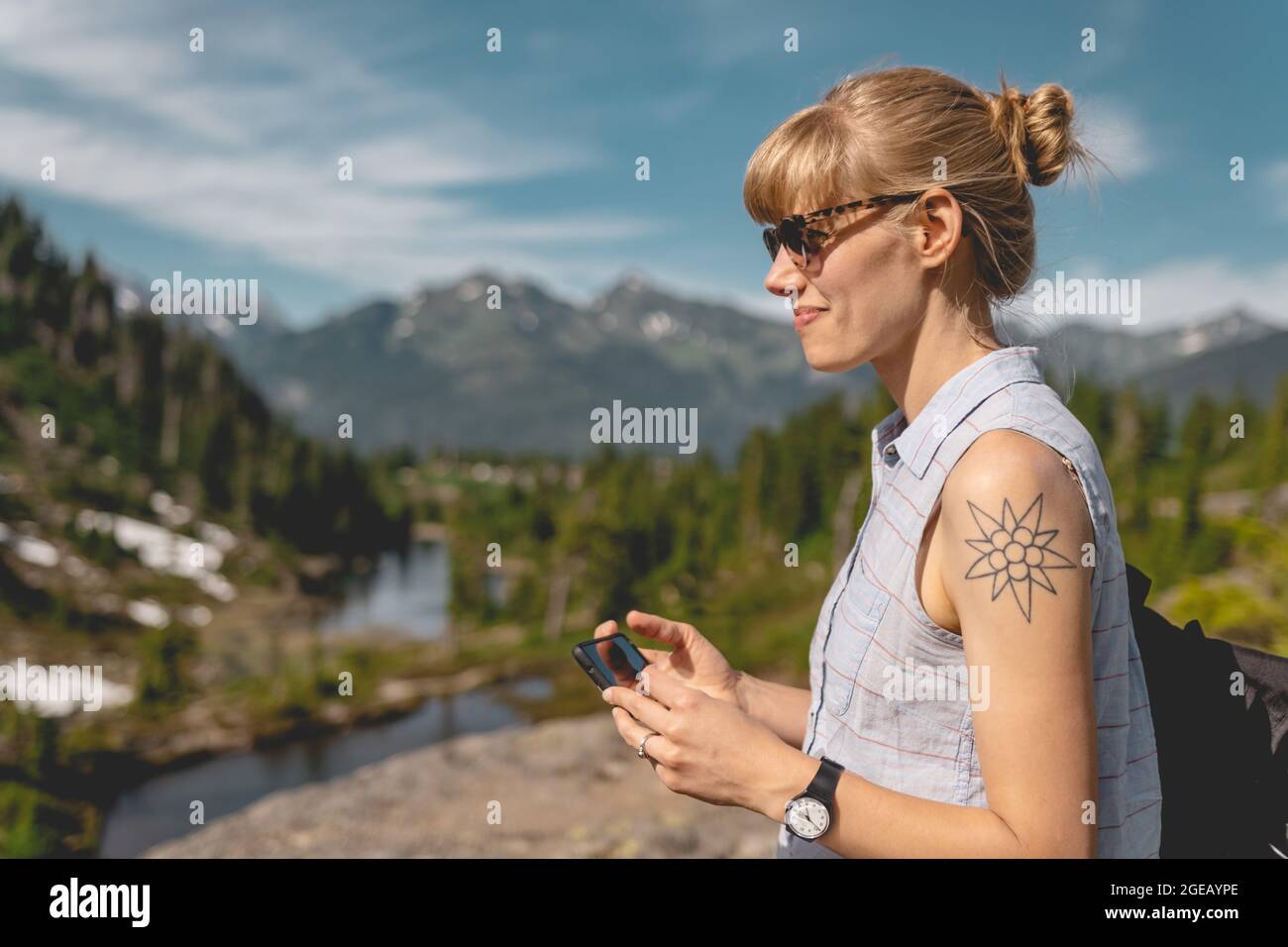 Young woman taking pictures at Heather Meadows in the Mt. Baker ...