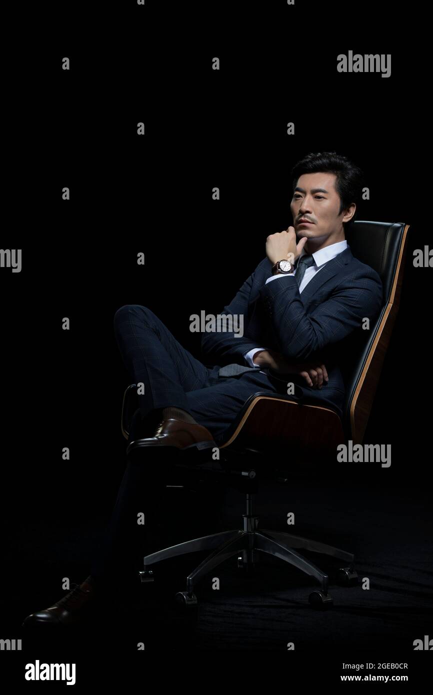 Successful Chinese businessman thinking Stock Photo - Alamy