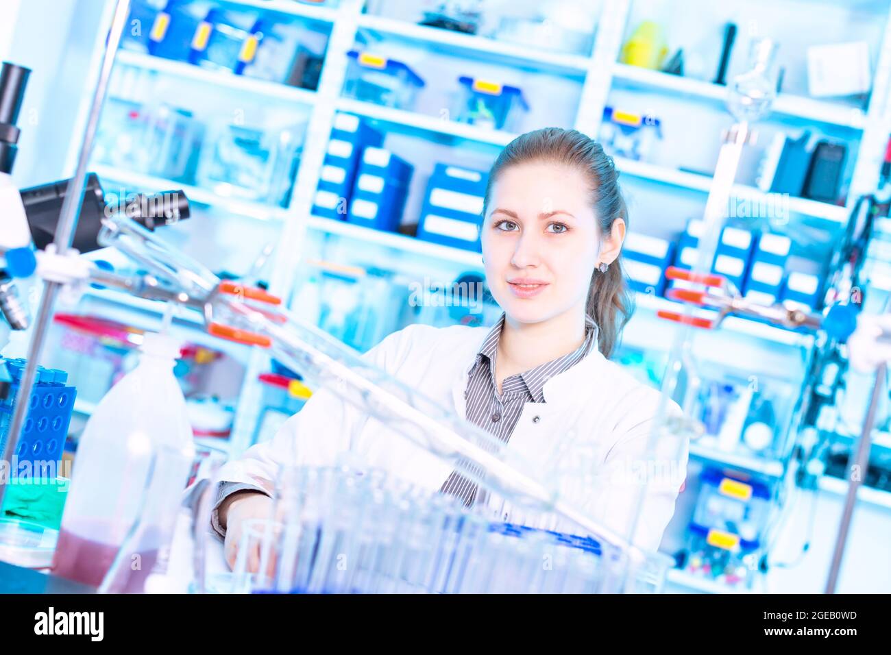 Young female student at university chemistry laboratory smiling and ...