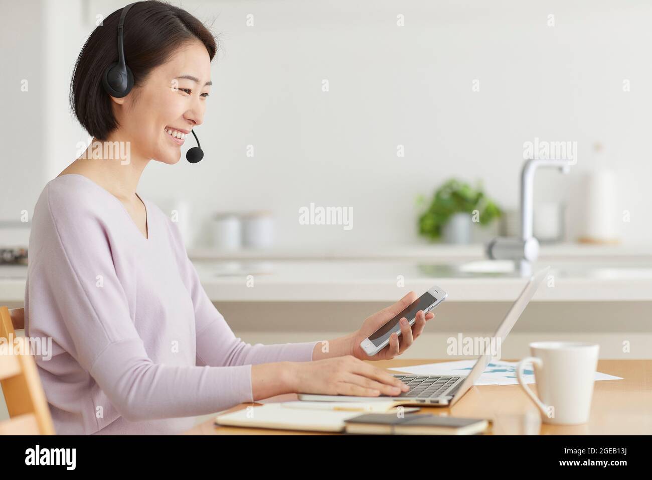 Asian woman earphones smartphone home hi-res stock photography and ...