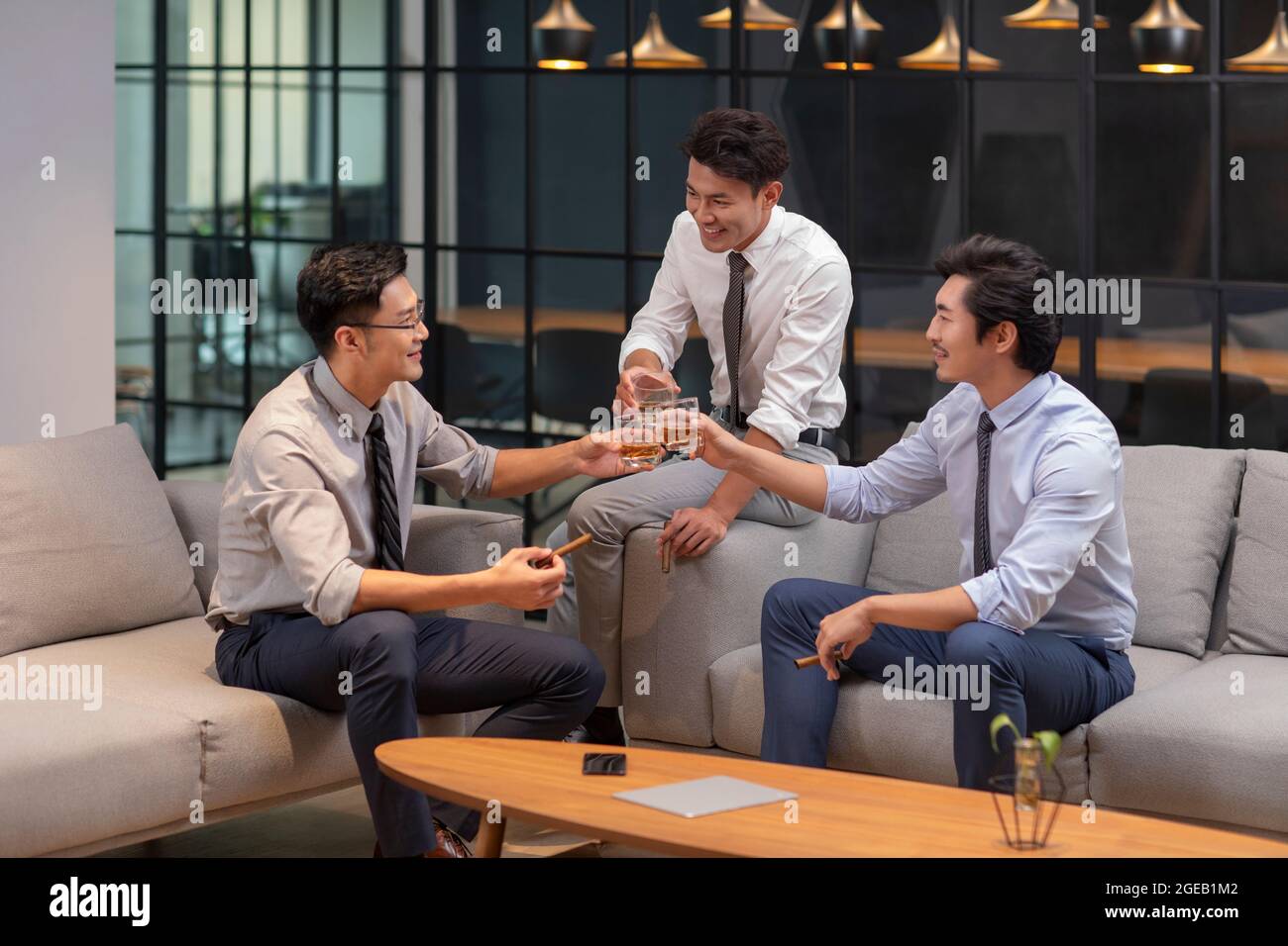 Successful Chinese businessmen drinking a toast in office Stock Photo ...