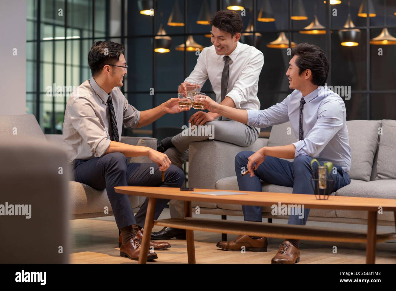 Successful Chinese businessmen drinking a toast in office Stock Photo ...